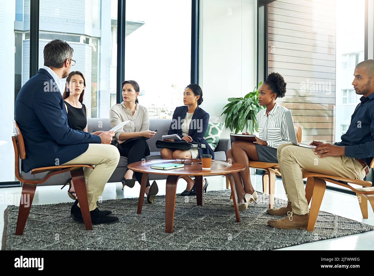 Talking strategy with the team. a group of work colleagues talking ...