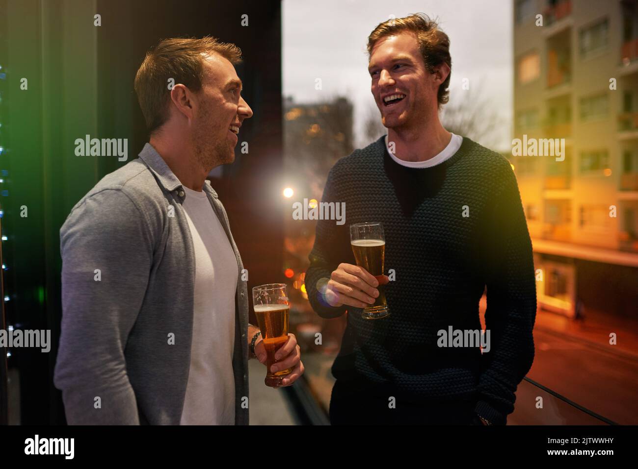 Catching up over some beers. guys talking while drinking beer at a ...