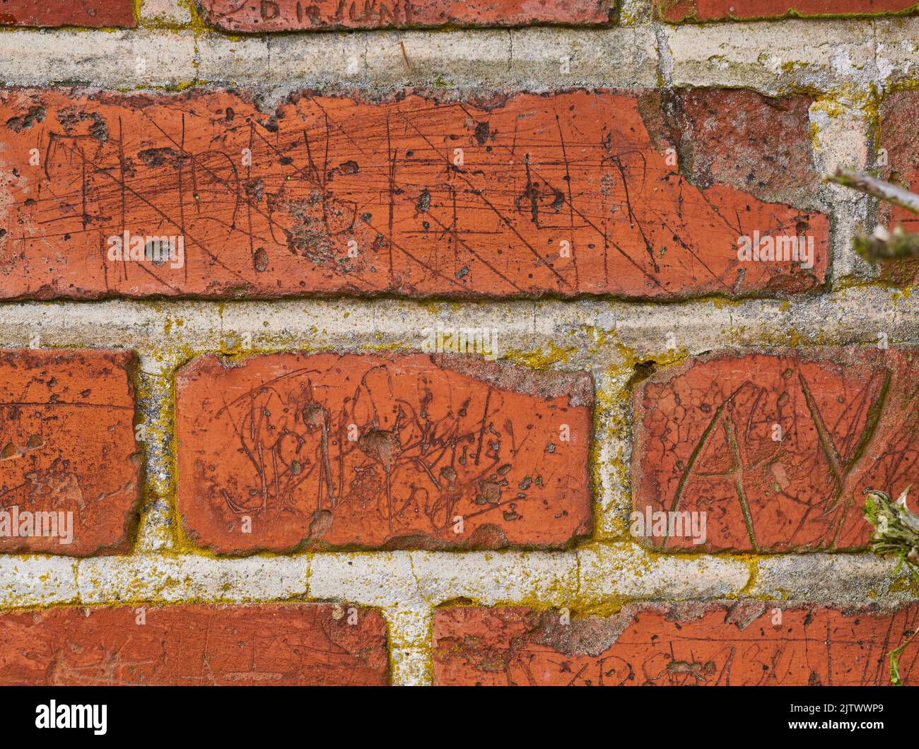 Signature wall. A photo of brick wall of an old school with a lot of ...