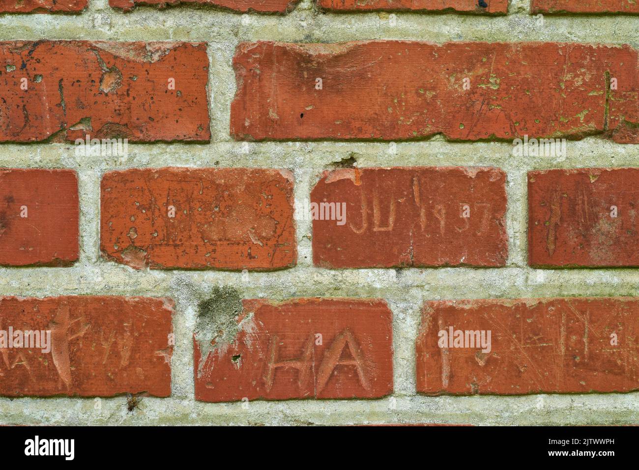 Signature wall. A photo of brick wall of an old school with a lot of ...