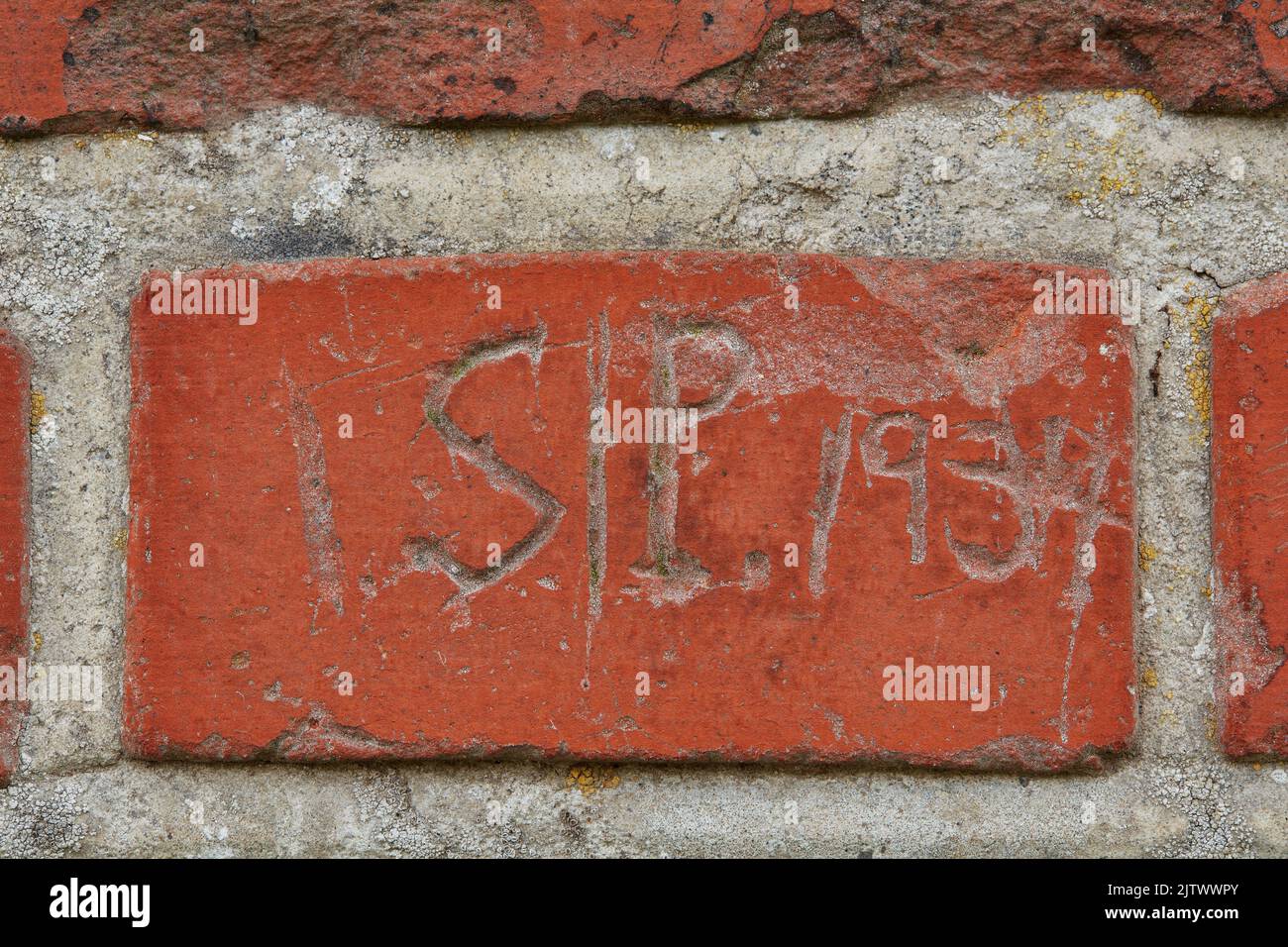 Signature wall. A photo of brick wall of an old school with a lot of ...