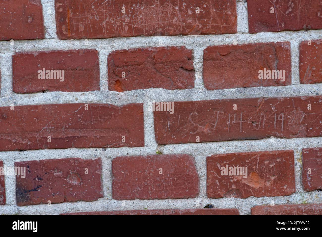 Signature wall. A photo of brick wall of an old school with a lot of ...