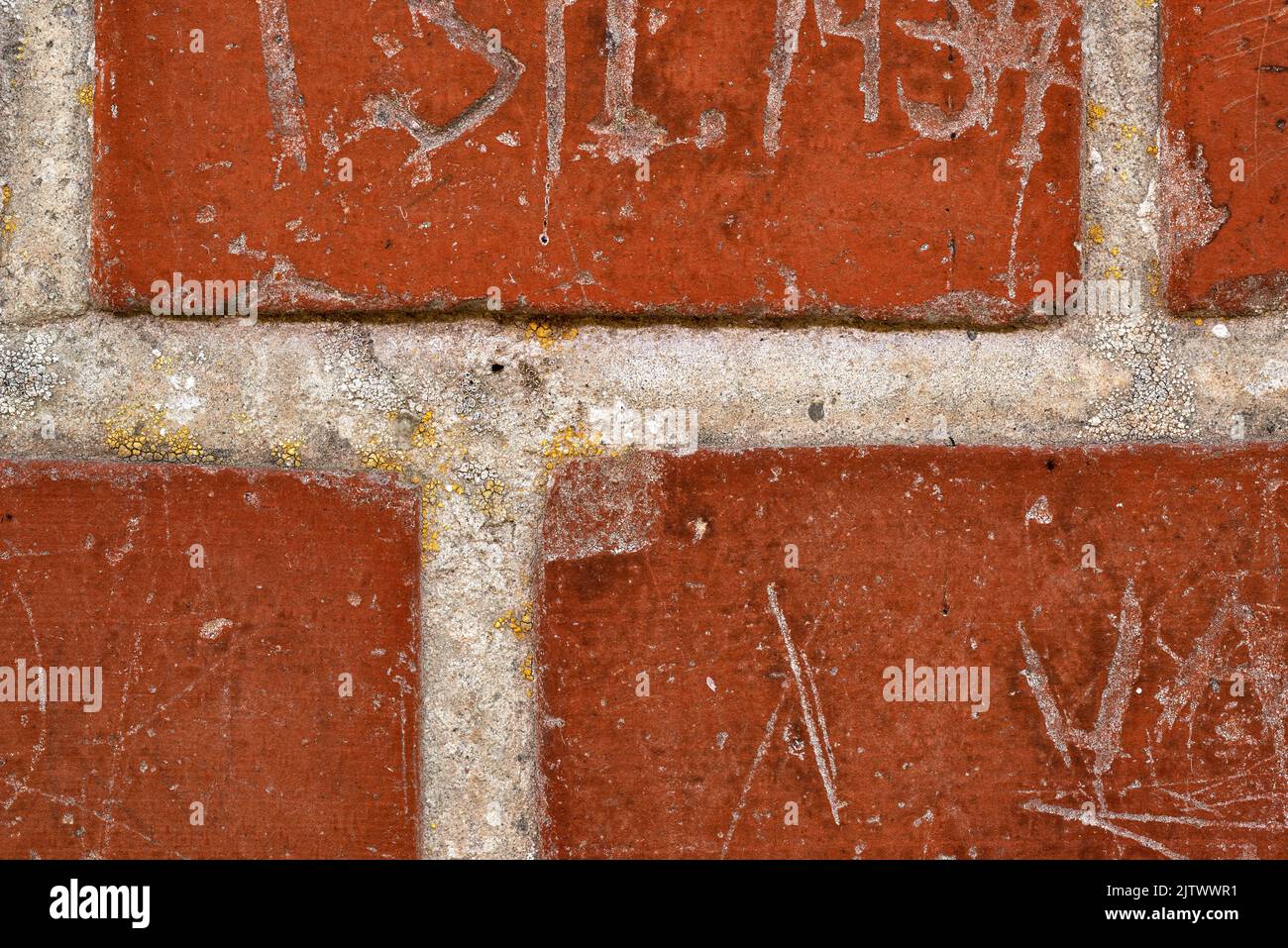 Signature wall. A photo of brick wall of an old school with a lot of ...