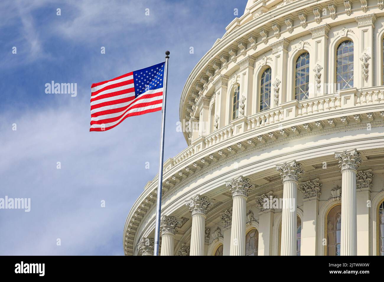 Washington DC Capitol dome detail with waving American flag Stock Photo ...