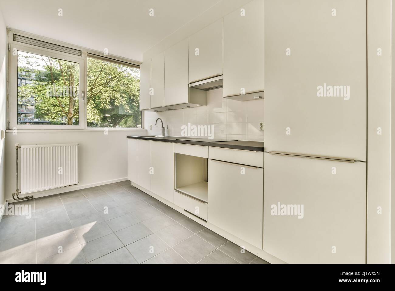 Interior of empty white kitchen with windows Stock Photo - Alamy