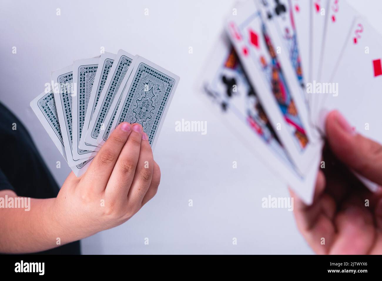 Two people playing poker raising their hands. People in the middle of ...