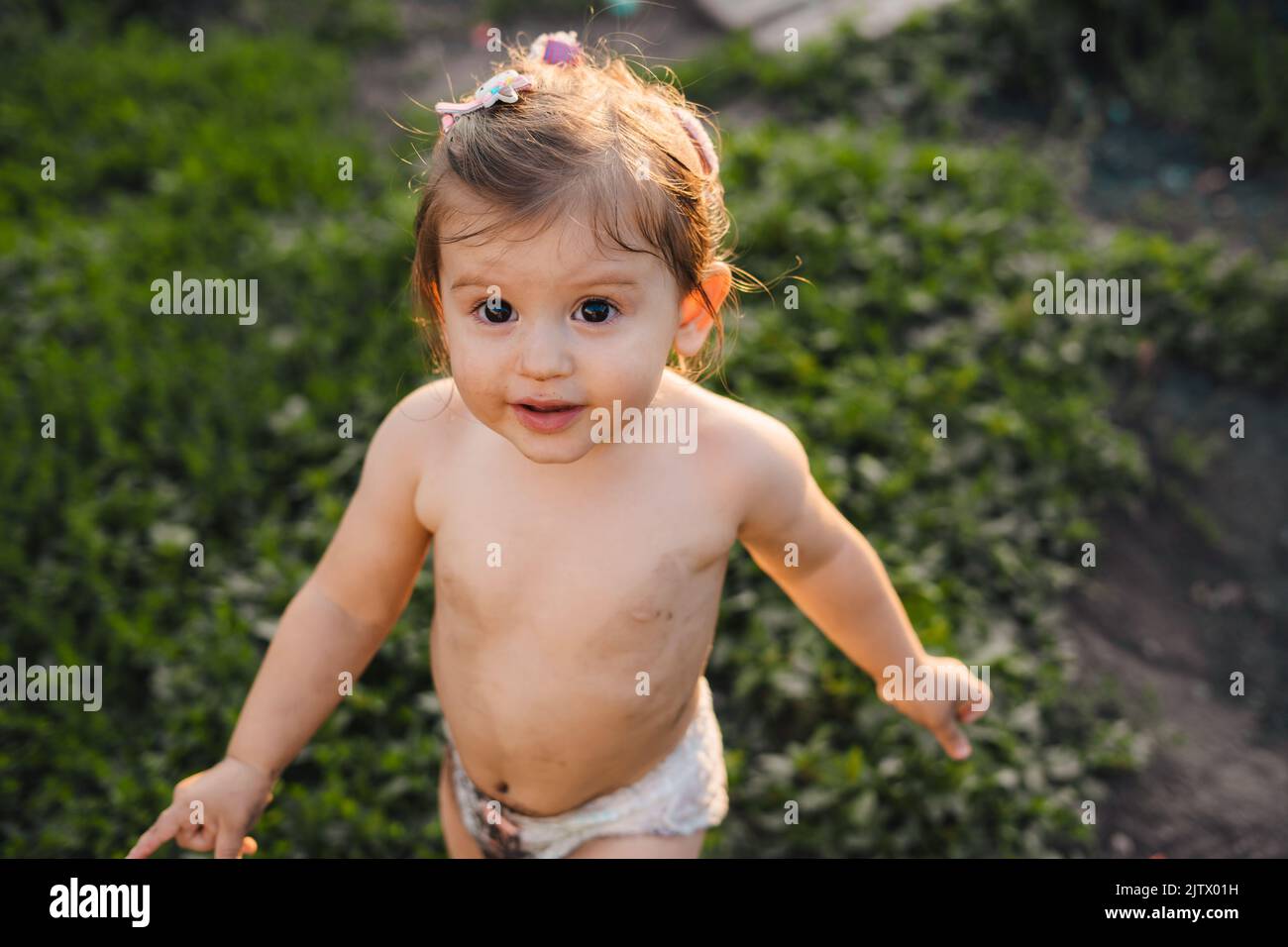 Baby girl enjoying walking and running freely through the country ...