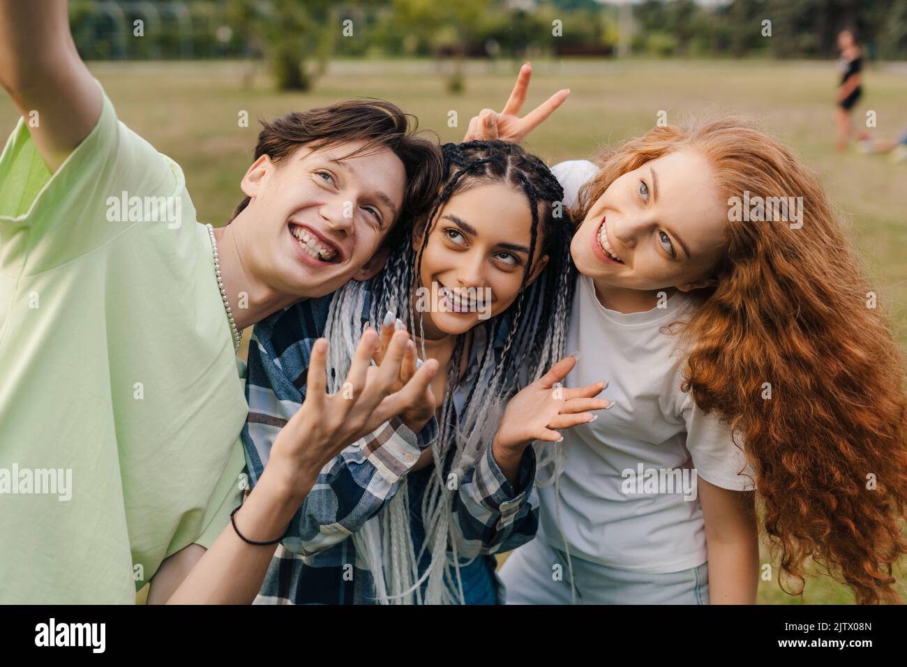 Happy Friends Having Fun Taking Group Selfie Portrait On City Park
