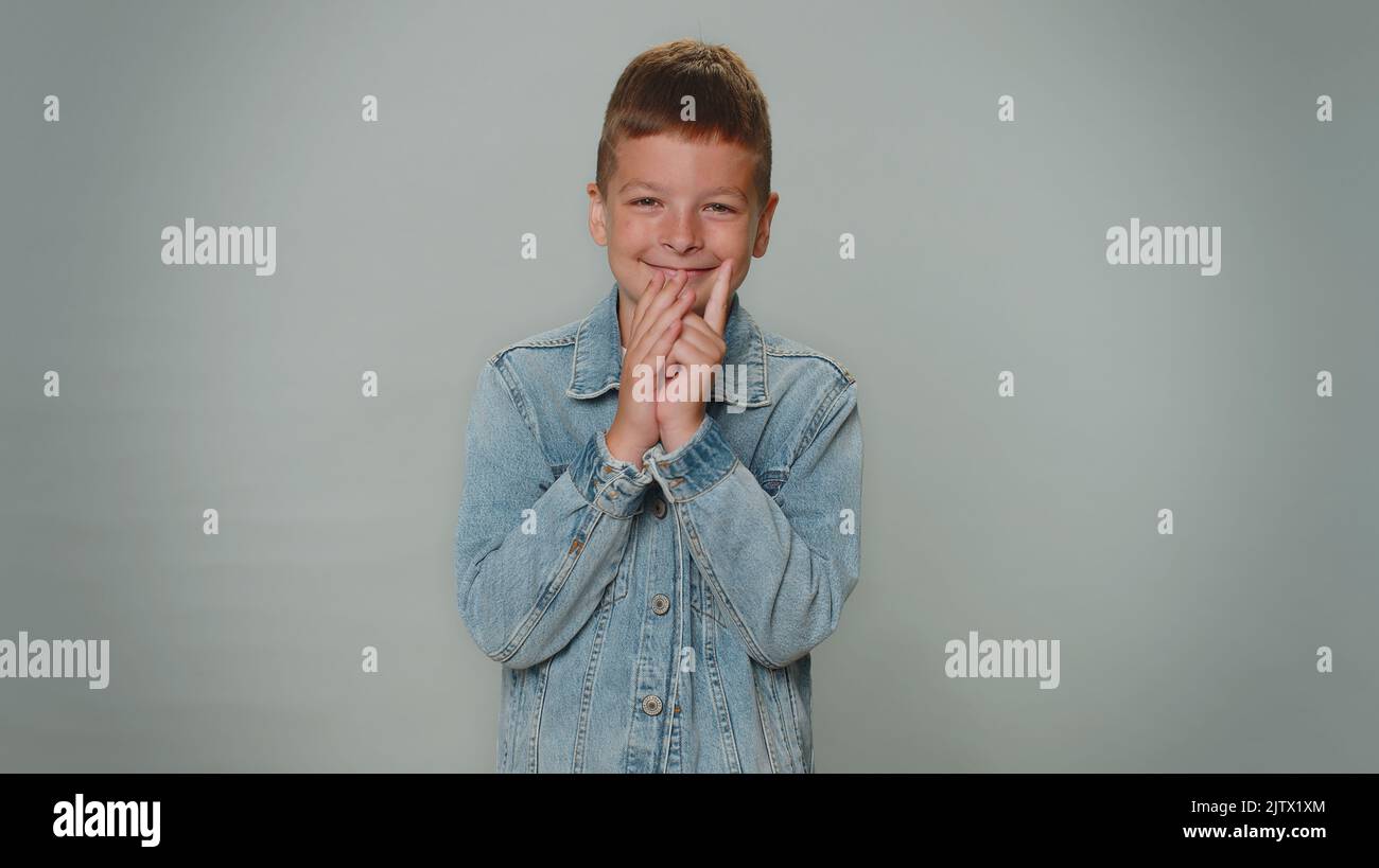 Sneaky cunning boy with tricky face gesticulating and scheming evil ...