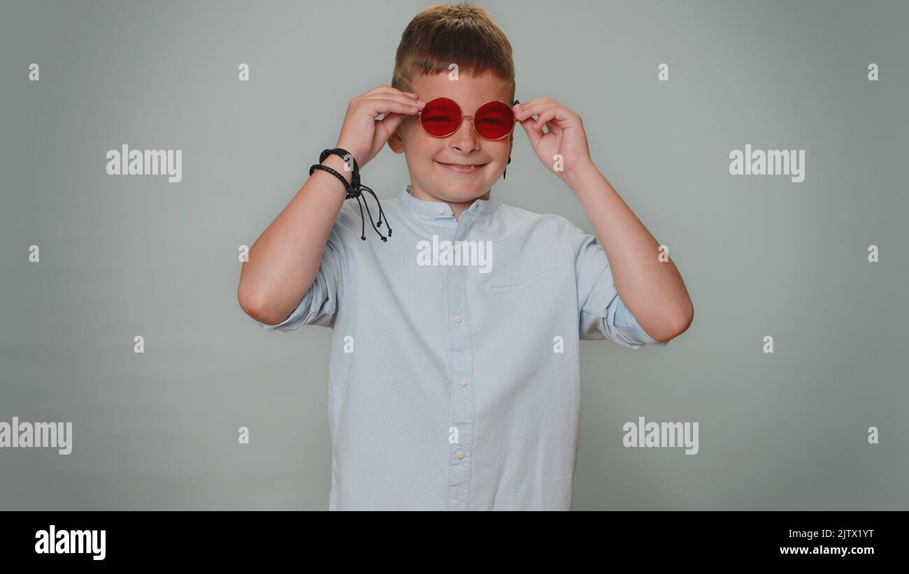Portrait of seductive cheerful stylish boy wearing sunglasses, charming ...
