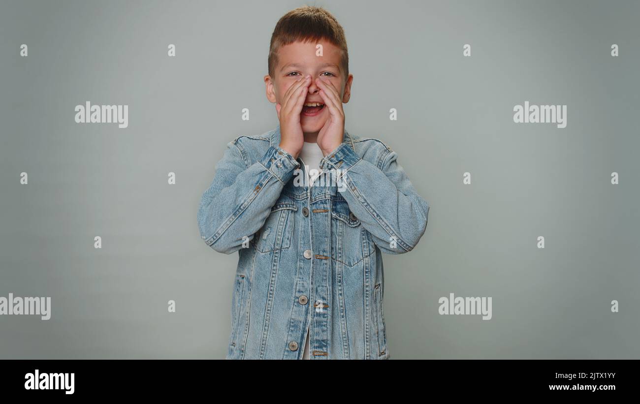 Expressive toddler kid boy holding hands near mouth loudly screaming ...