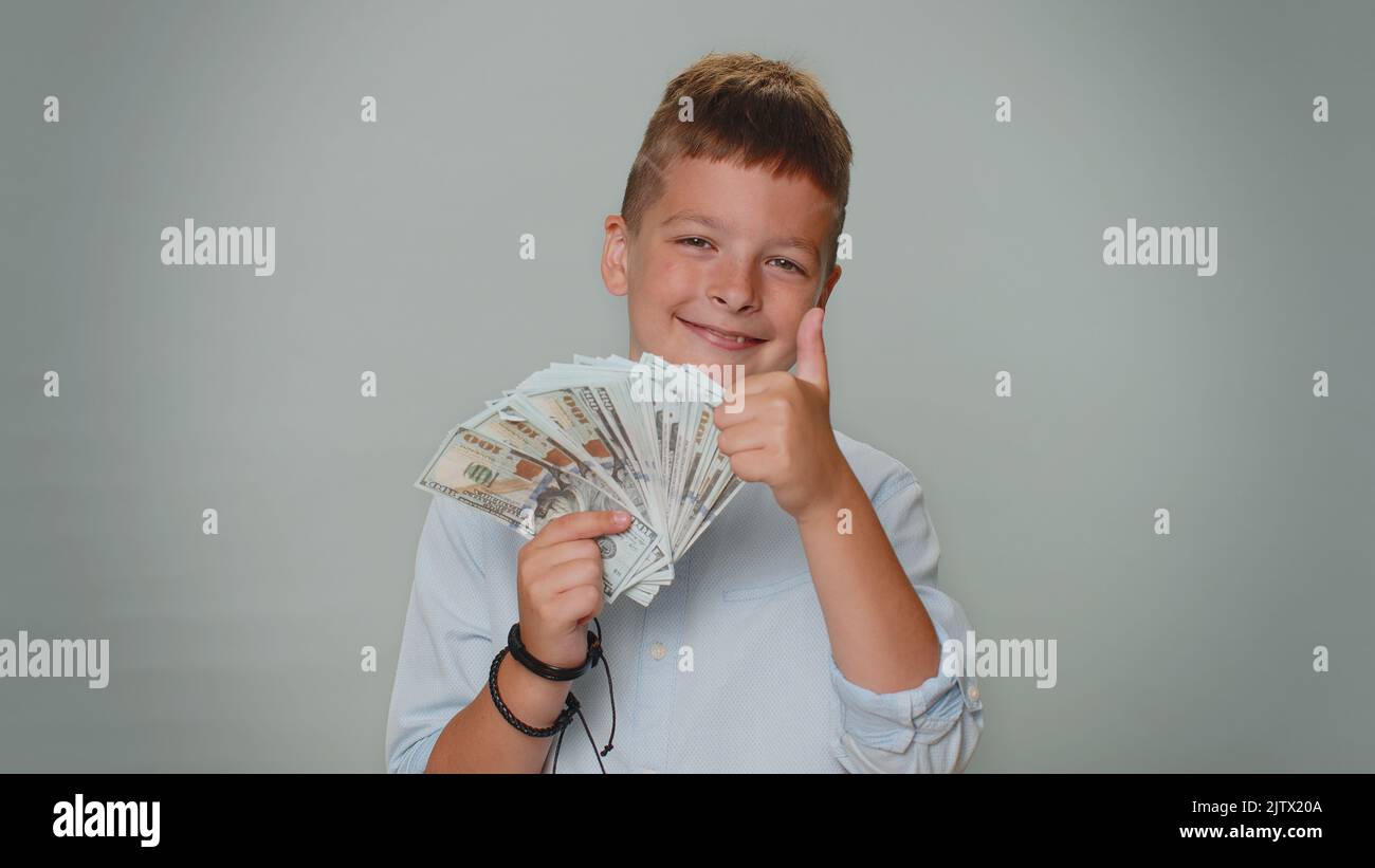 Toddler young boy holding fan of cash money dollar banknotes celebrate ...