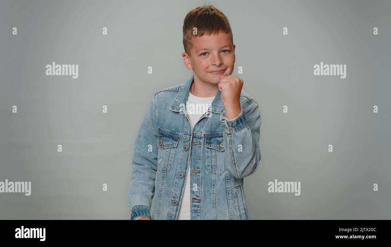 Aggressive angry toddler kid boy in jacket trying to fight at camera ...