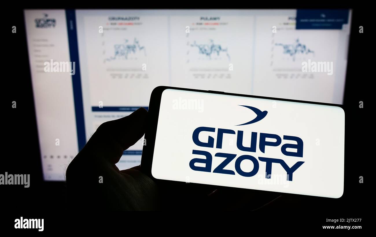 Person holding mobile phone with logo of Polish chemical company Grupa ...