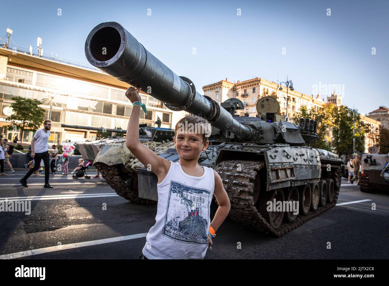 A little boy Sasha holds the turret barrel from a demolished Russian ...