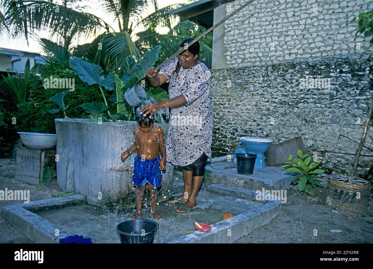 Maldivian woman spends a shower to her son, home island Mahembadhoo ...