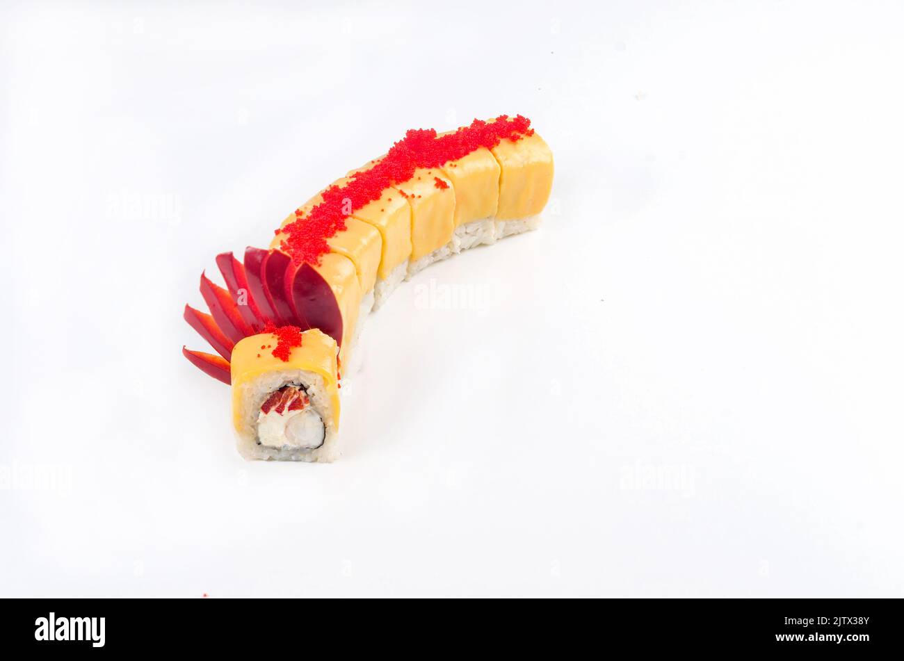 Yellow dragon sushi rolls with cheese decorated with red caviaron on ...