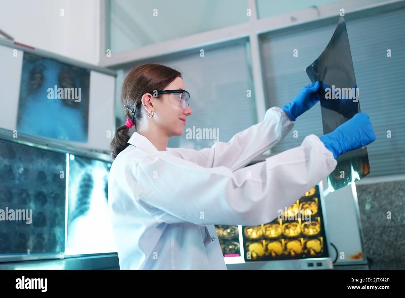 Team of doctors discuss results of X-Ray or MRI scan of patient's brain ...