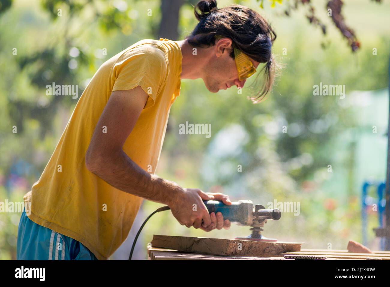 Close up of sanding a wood with orbital sander at workshop electric ...