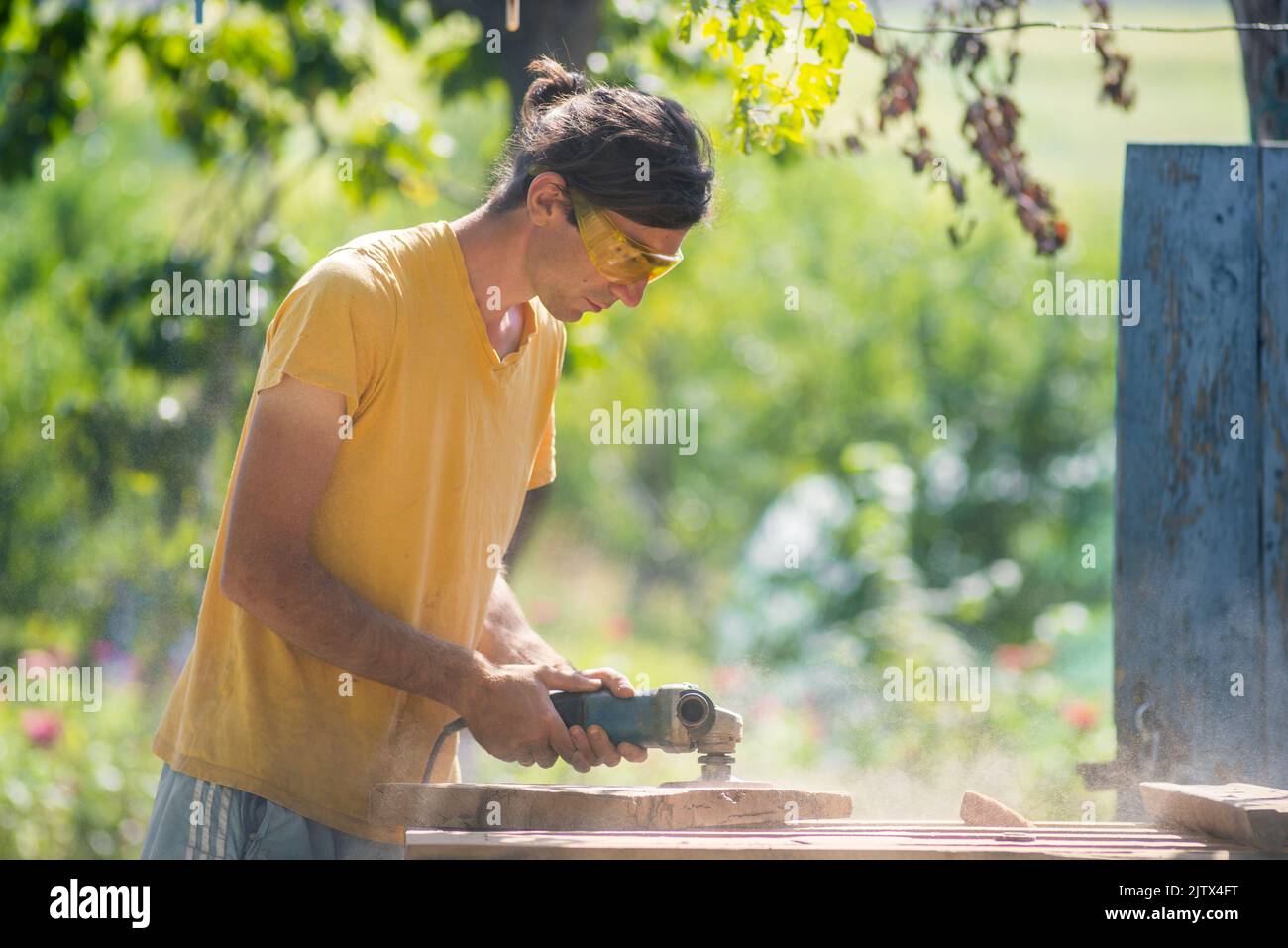 Close up of sanding a wood with orbital sander at workshop electric ...