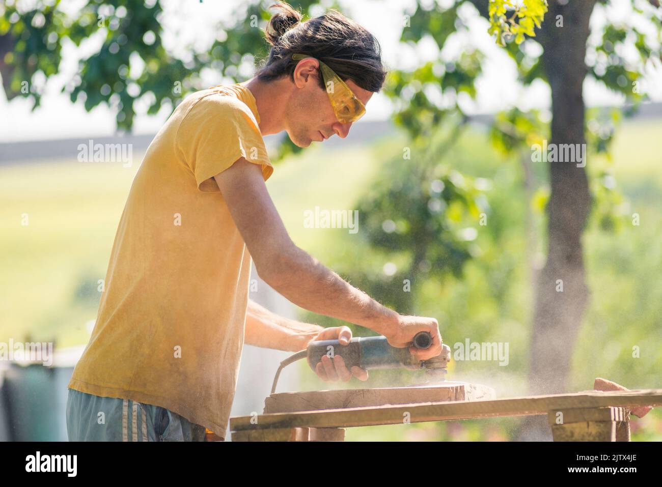 Close up of sanding a wood with orbital sander at workshop electric ...