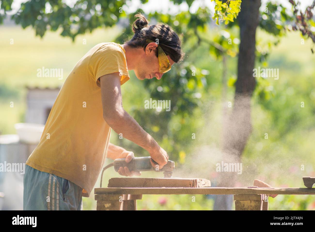 Close up of sanding a wood with orbital sander at workshop electric ...
