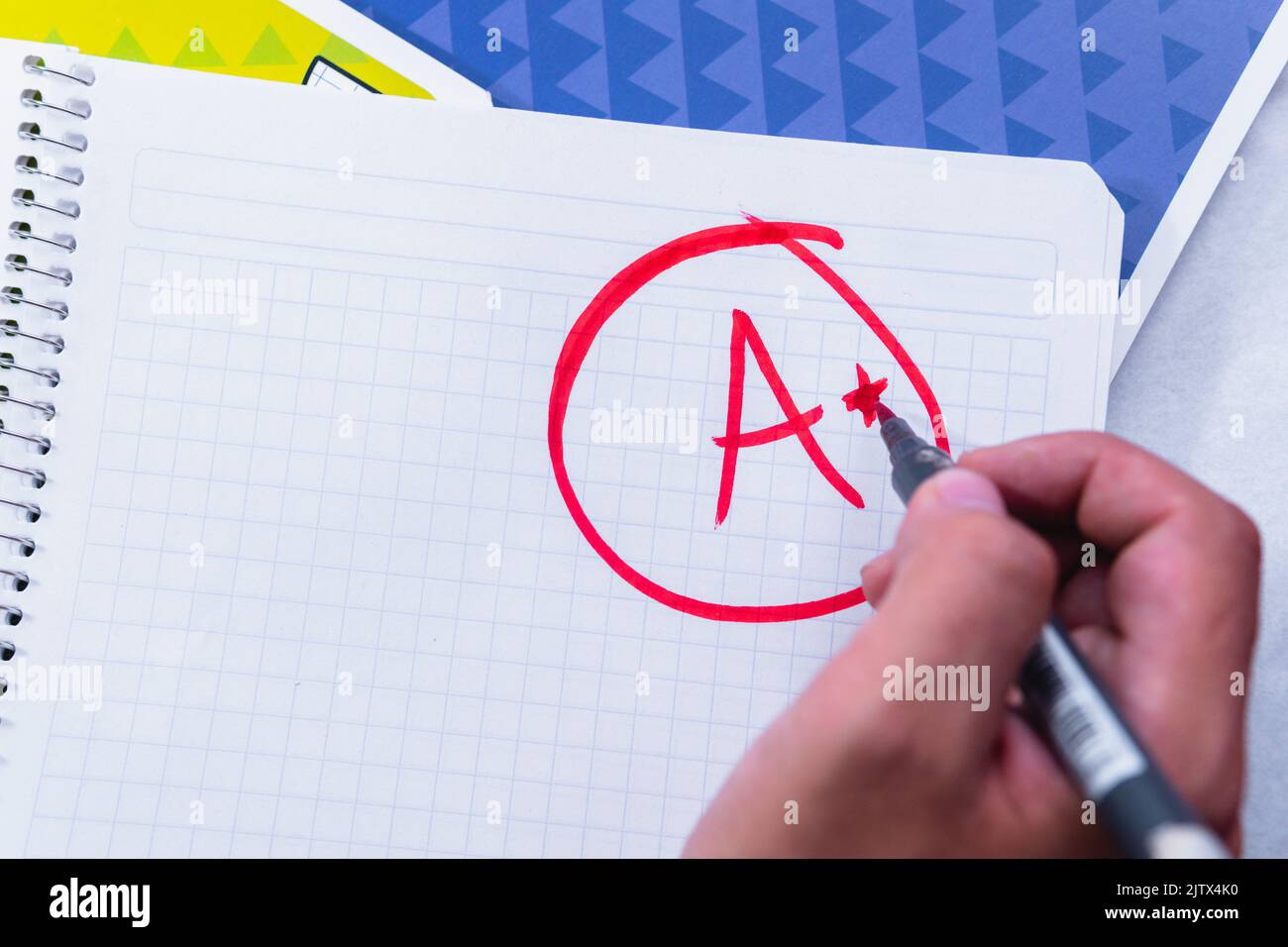 Teacher giving an A+ to a student's assignment. Blank sheet with copy ...