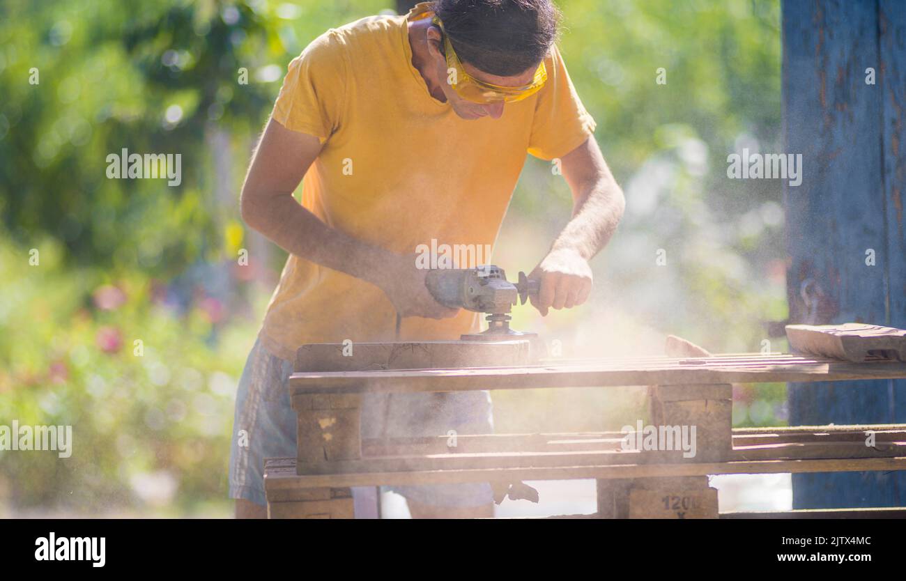 Close up of sanding a wood with orbital sander at workshop electric ...