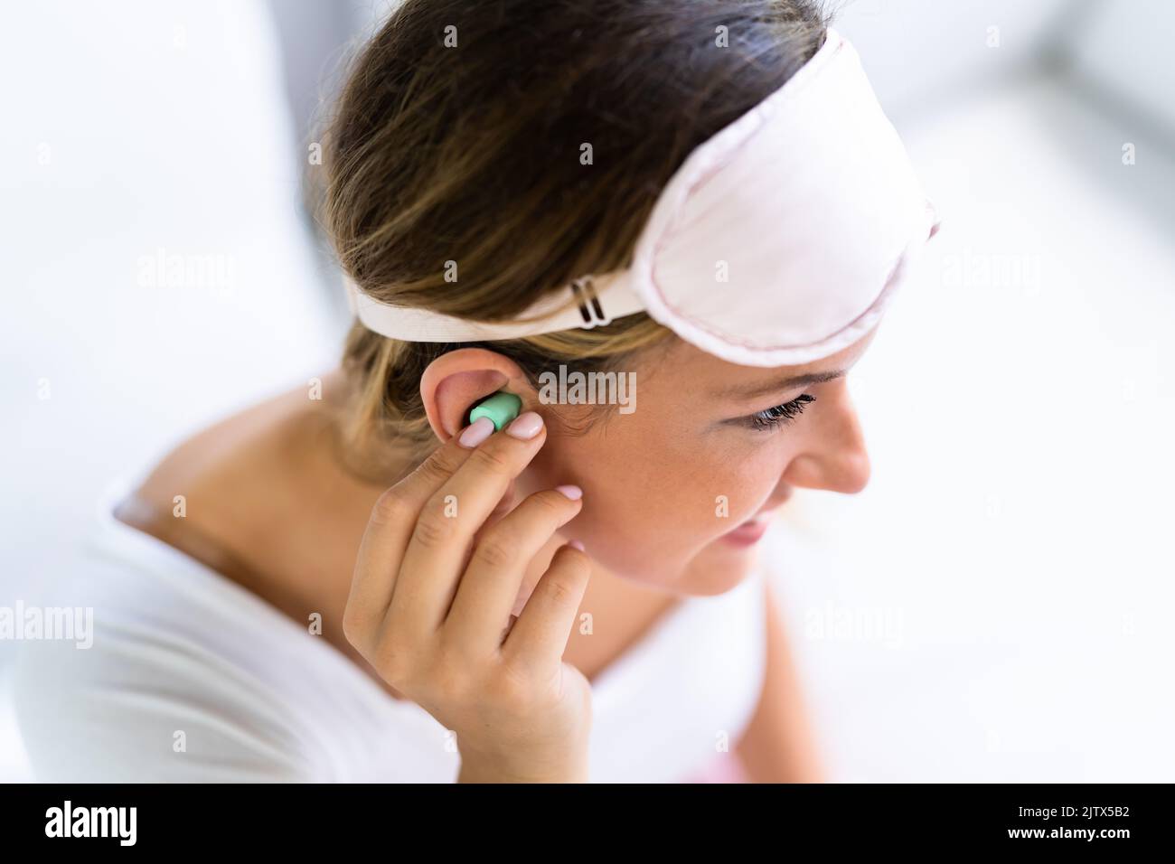 Woman Using Ears Stoppers In Home Bedroom Stock Photo - Alamy