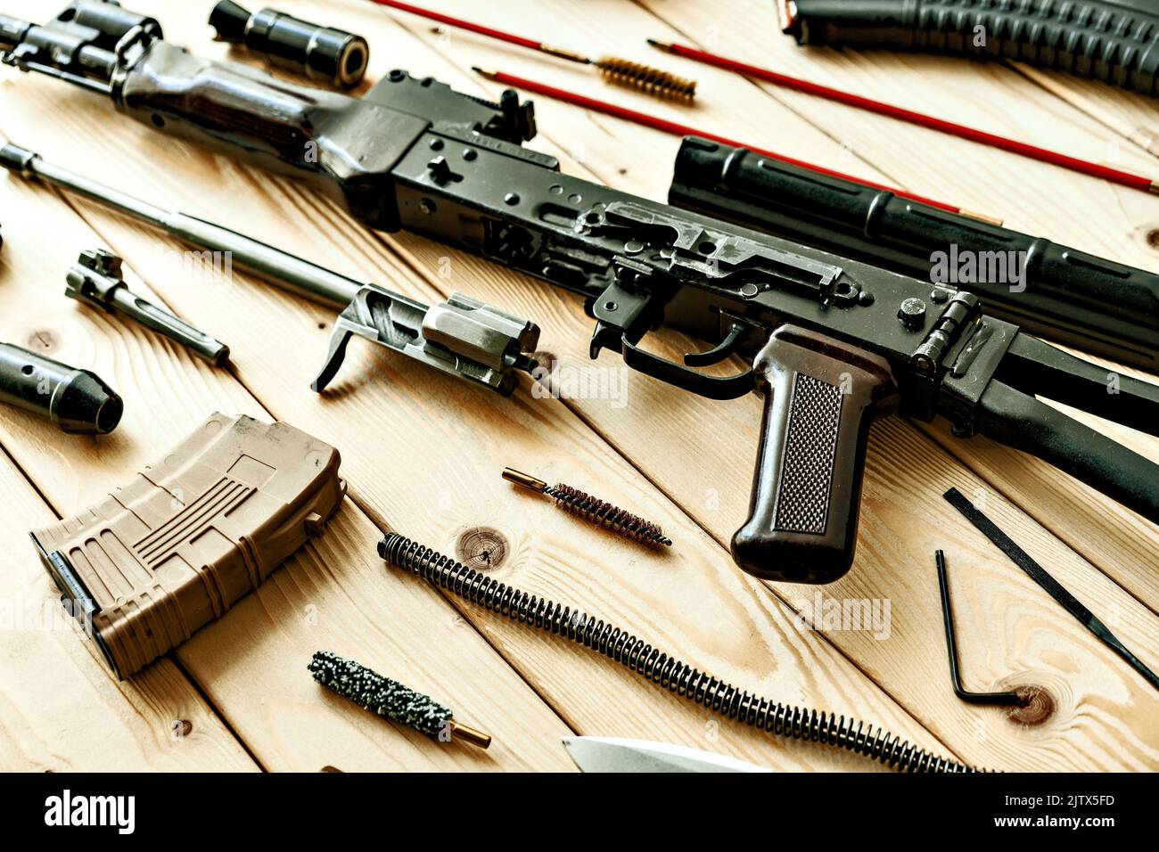 Disassembled rifle with cleaning tools on table of weapons workshop ...