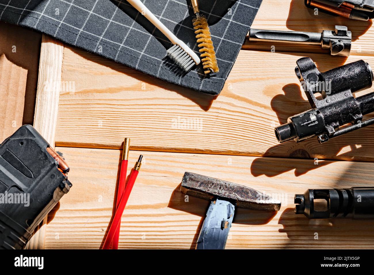 Black disassembled shotgun and cleaning tools on wooden table Stock ...
