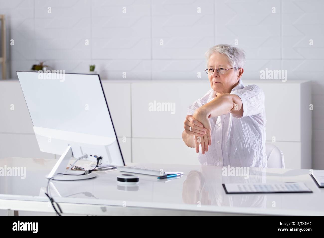 Office Worker Stretching And Relaxed Behind PC Stock Photo - Alamy