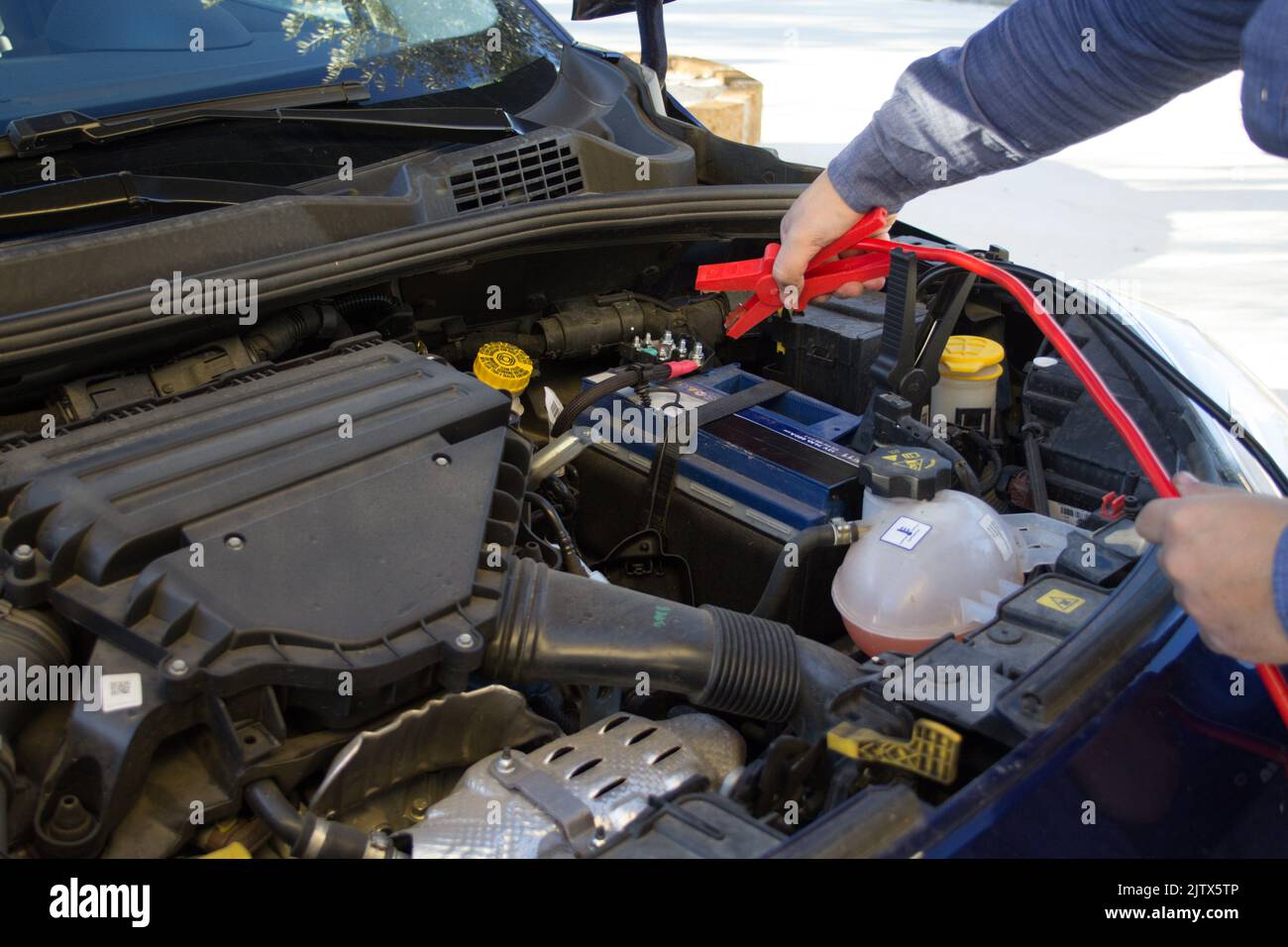broken down car with low battery. Starting with cables Stock Photo - Alamy