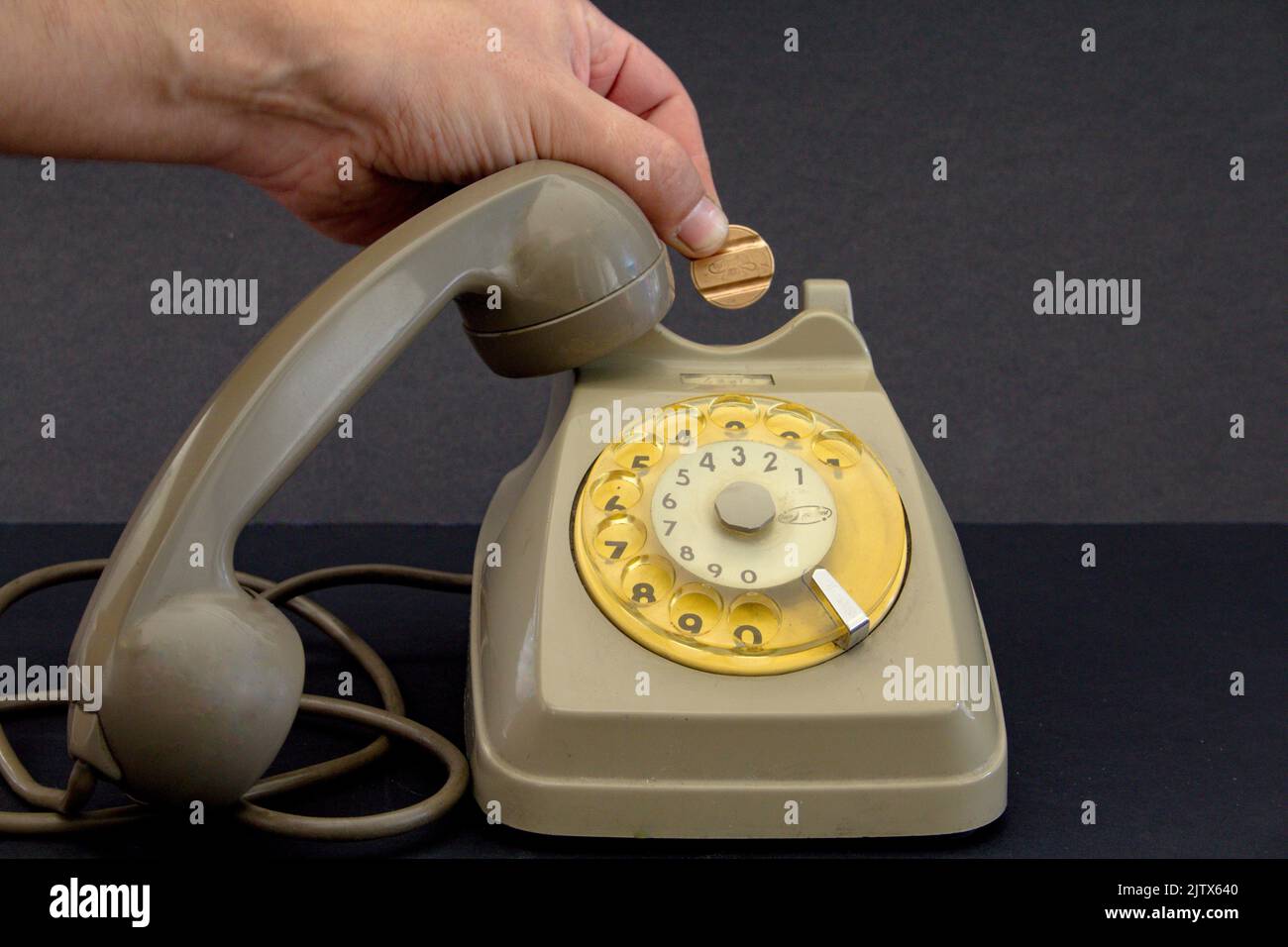 old vintage wheel phone and hand with telephone token Stock Photo - Alamy