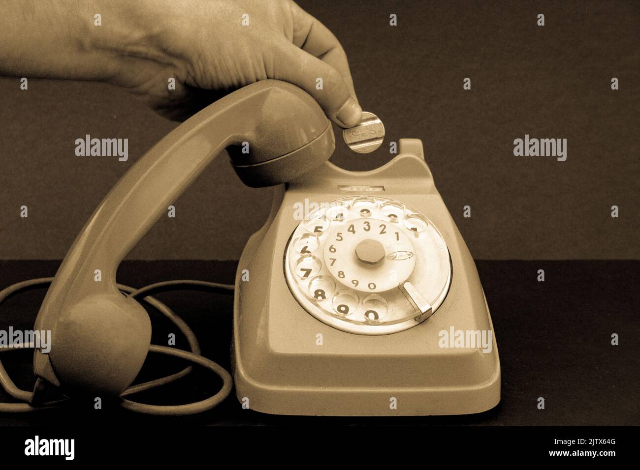 old vintage wheel phone and hand with telephone token Stock Photo - Alamy