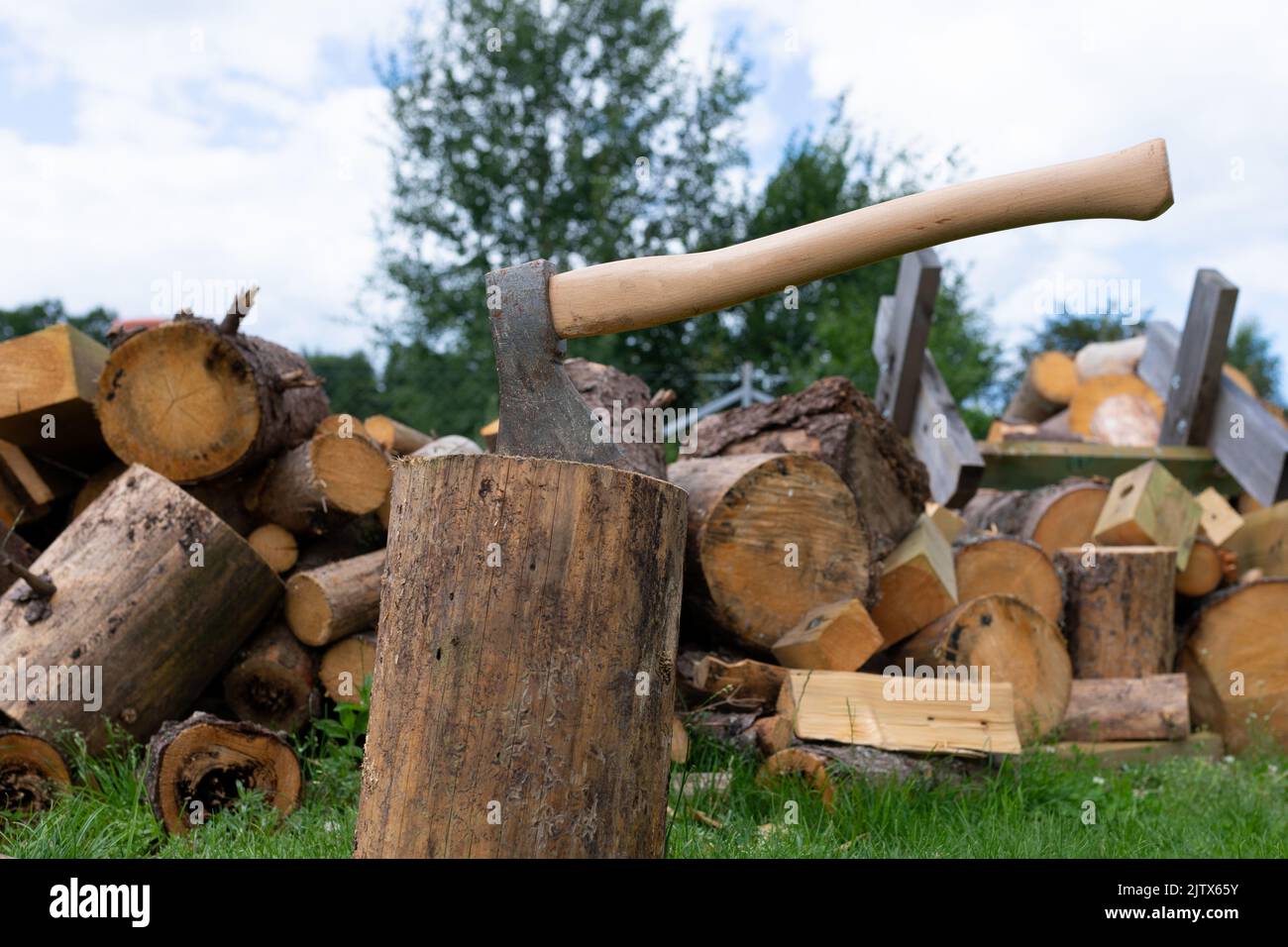 an ax for chopping wood close-up against the background of cut blocks ...