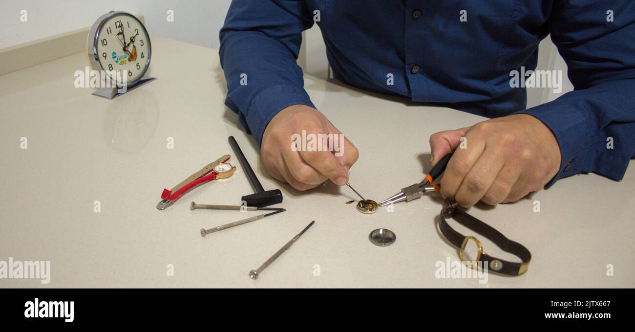 hands of a man while repairing watches. Watchmaker at work Stock Photo ...