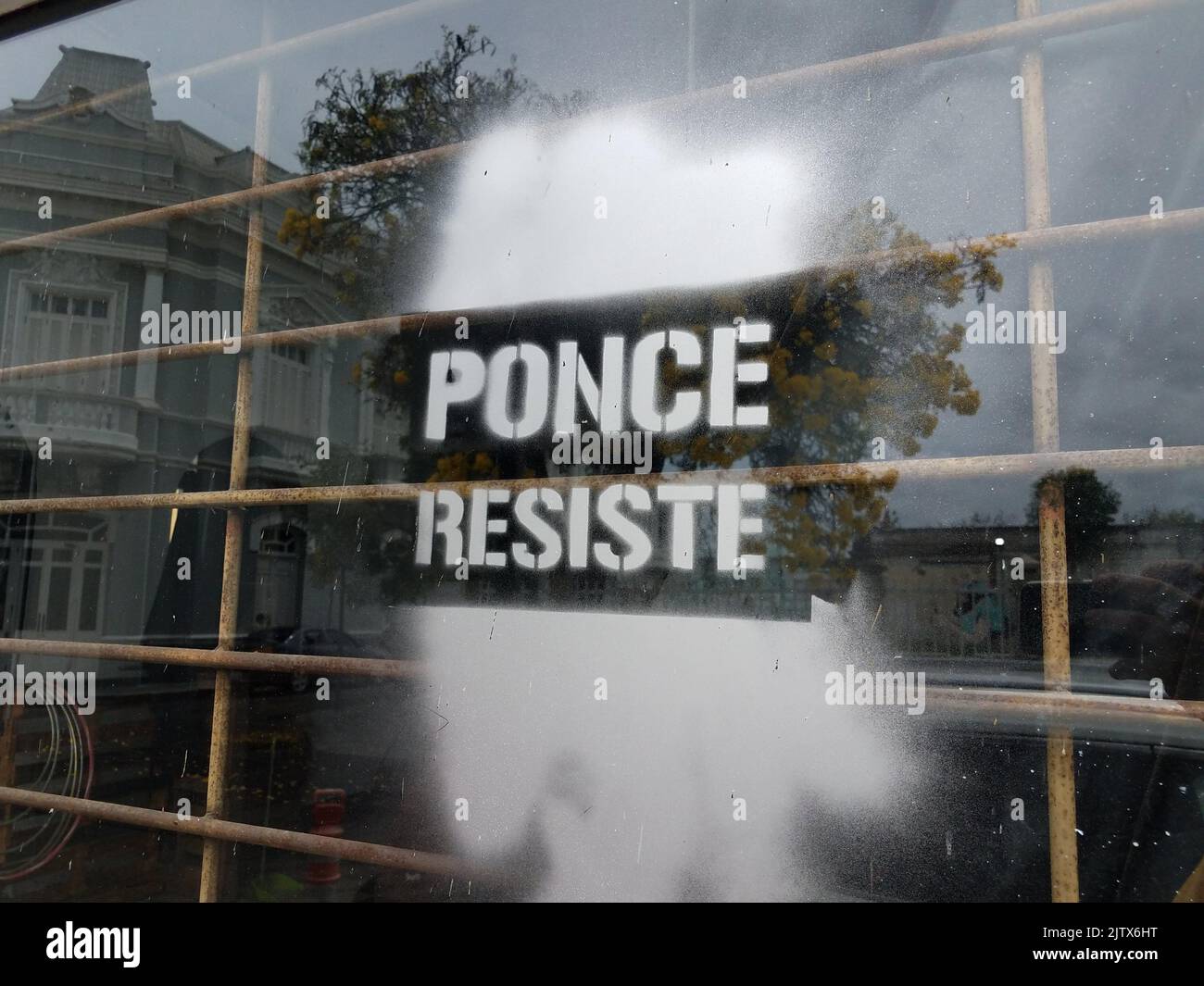 Ponce resist sign spray painted on glass window in Ponce Puerto Rico ...