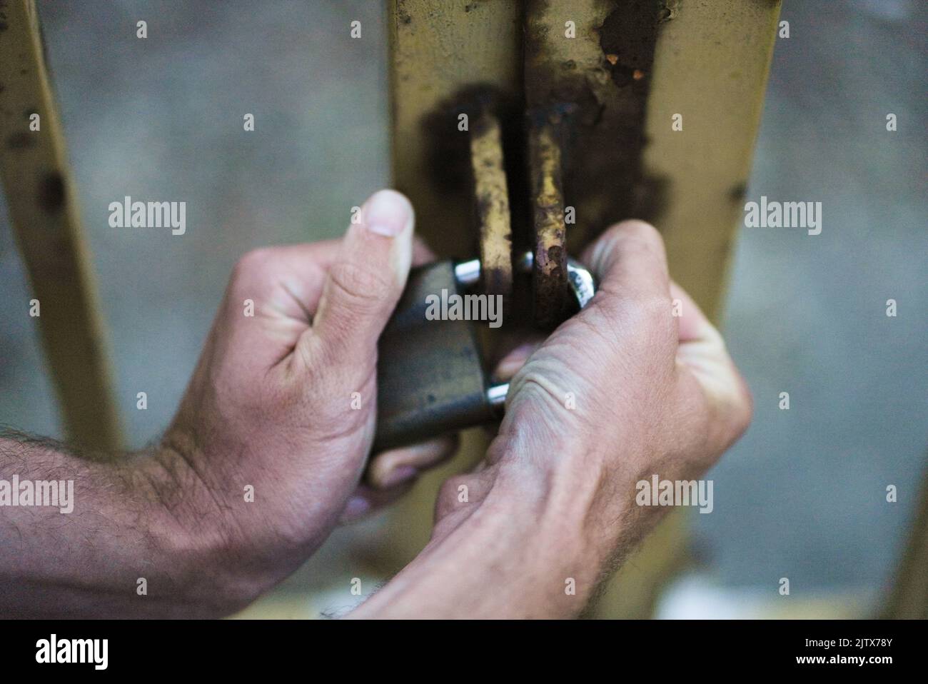 Trying to pull a lock apart with two hands Stock Photo - Alamy