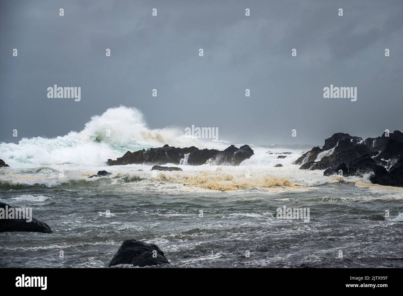 Big wave on rocky coast in stormy weather Stock Photo - Alamy