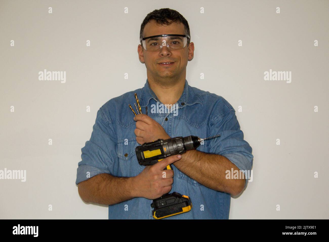 boy with screwdriver drill and bits in hand. Fix everything in the ...