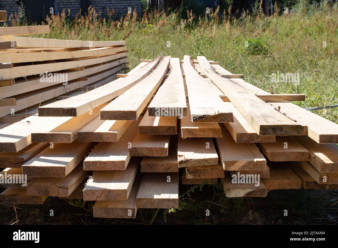 Folded finished boards at the sawmill close up Stock Photo - Alamy