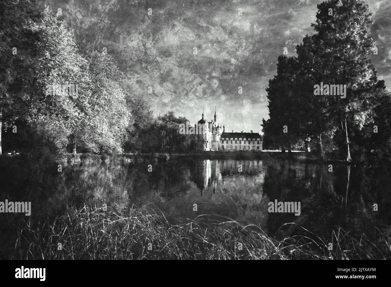 View of Chantilly castle reflected in pool surrounded by park trees ...