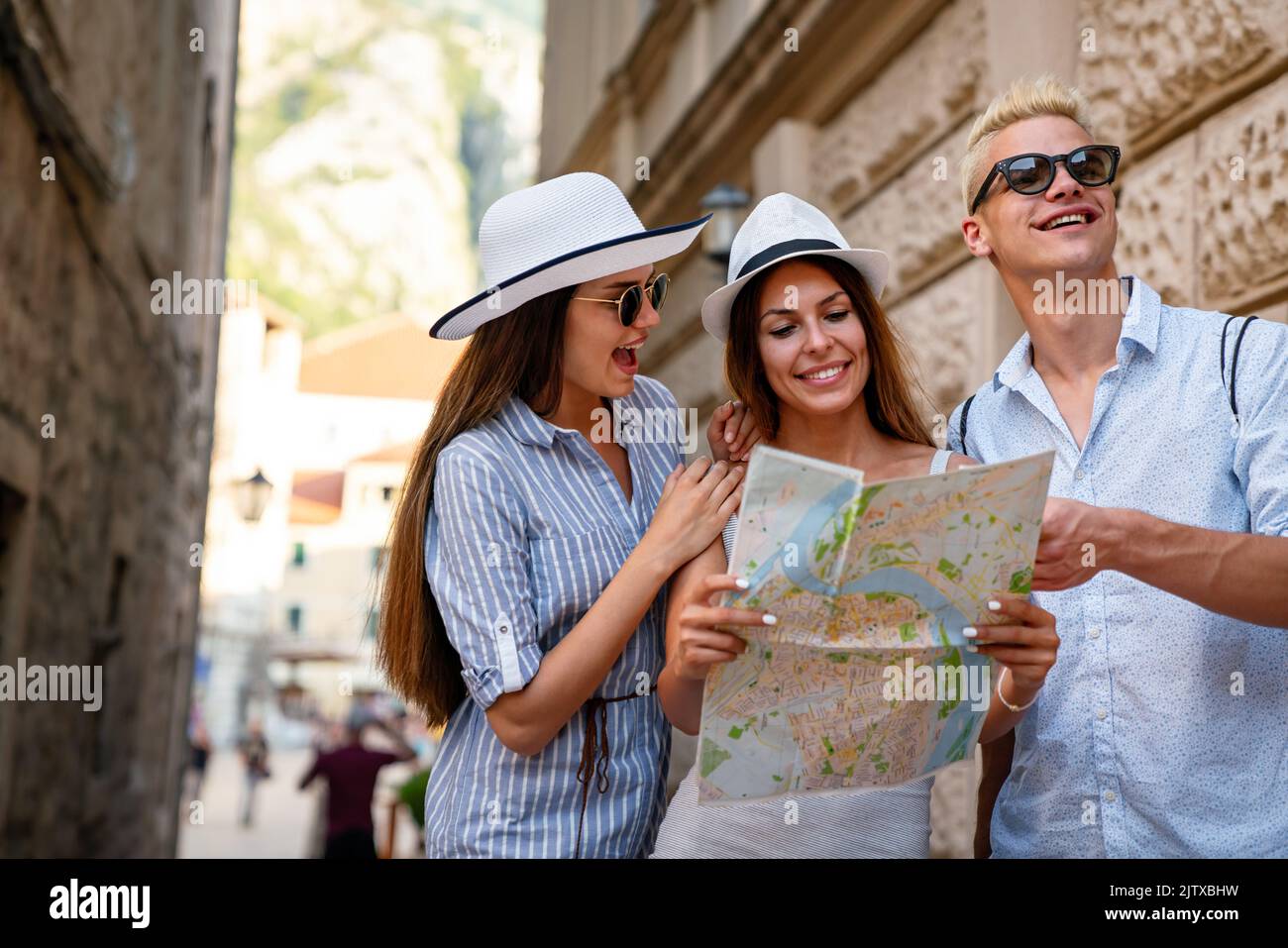 Happy group of young friends enjoying sightseeing tour in the city on ...