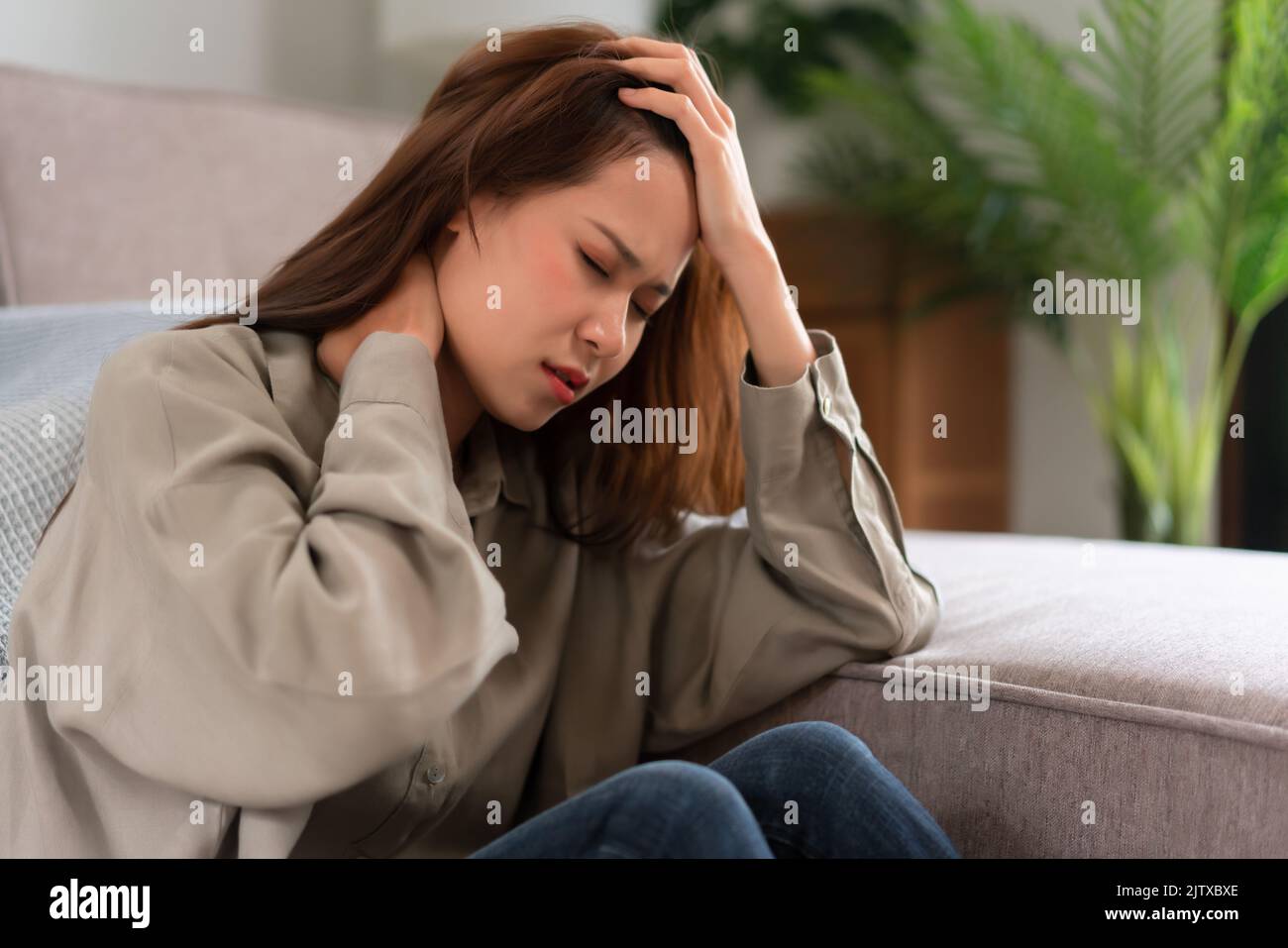 Concept of relaxation with music, Young asian woman feeling headache ...