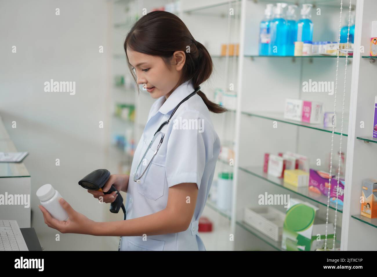 Medicine and health concept, Female pharmacist scanning medicine ...