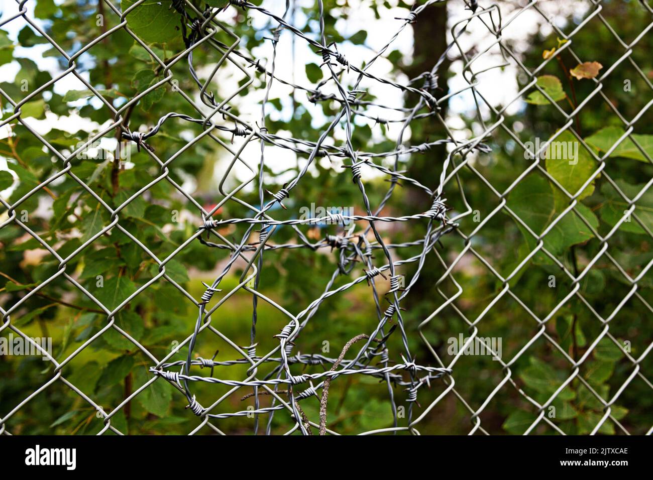 broken fence mended with barbed wire Stock Photo - Alamy