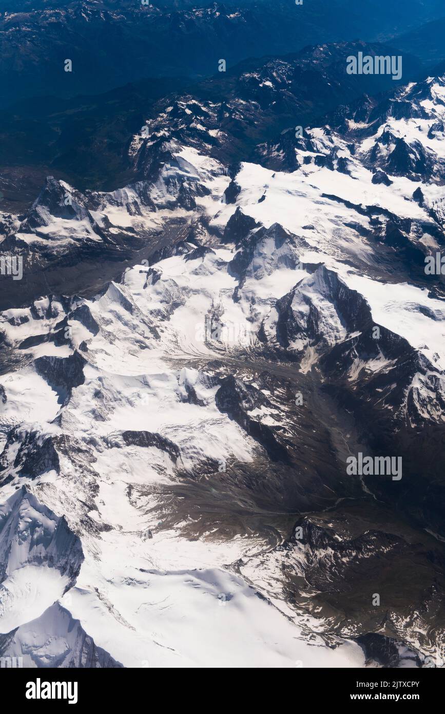 Snowy peaks of the Alps mountain range seen from an airliner, Europe ...