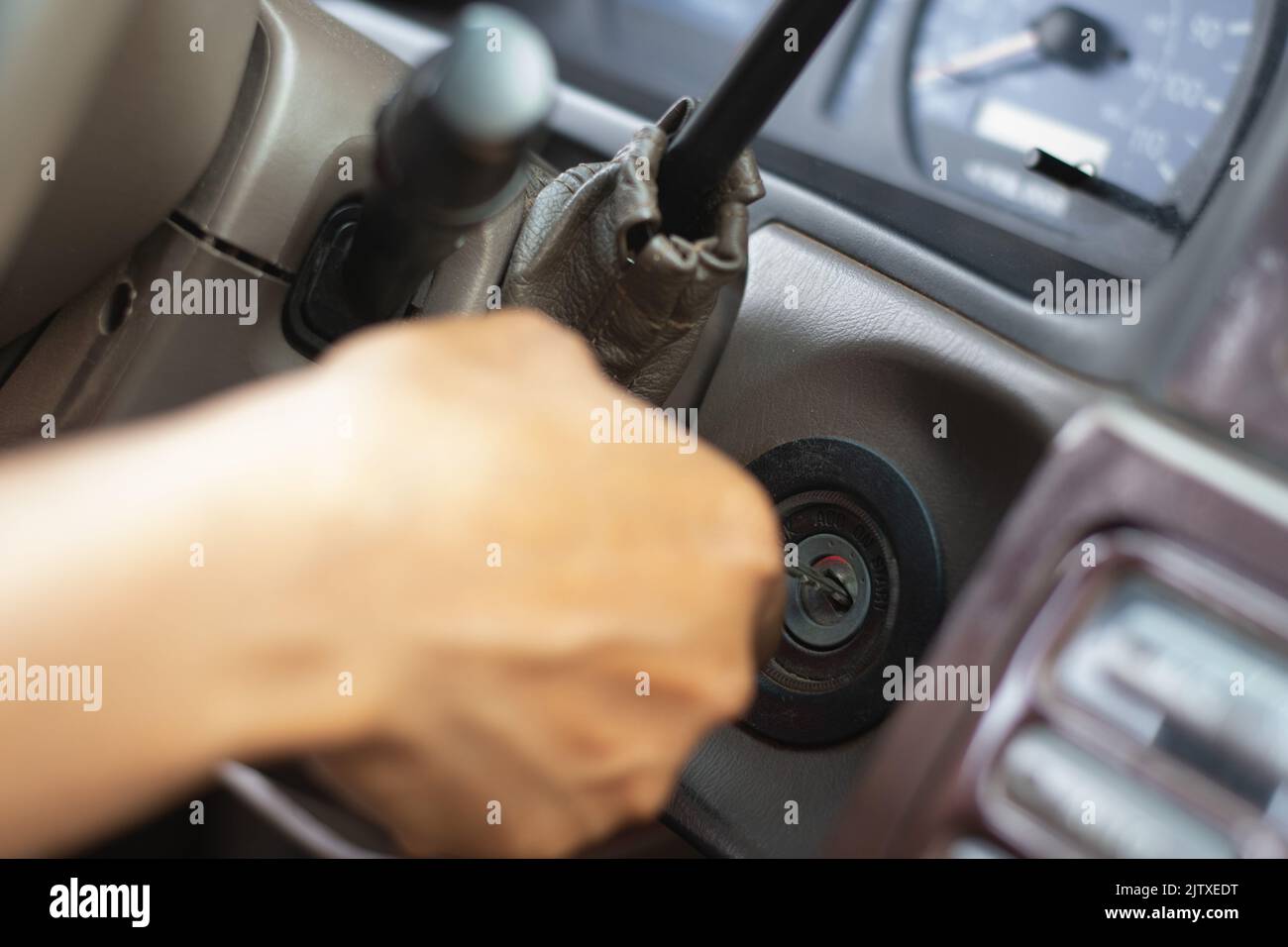 black person putting a key into the car ignition Stock Photo - Alamy