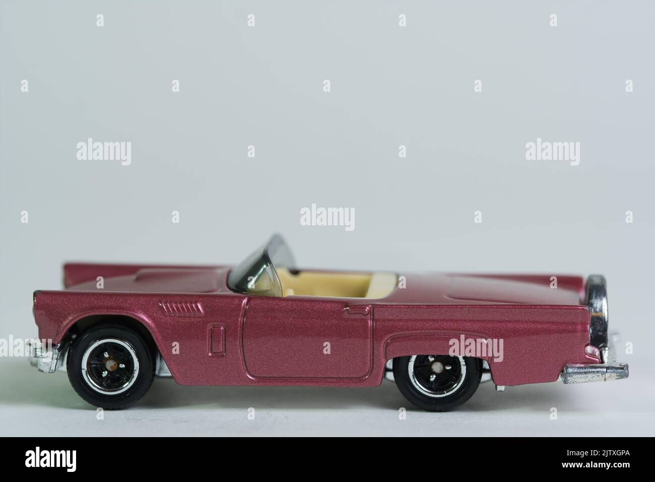 isolated pink cabriolet retro toy car on white background, side view ...